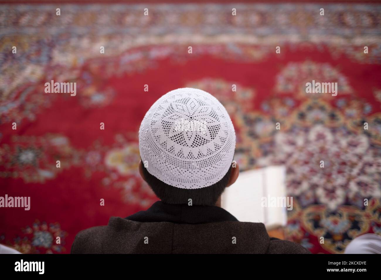 An Iranian-Sunni boy reads the Koran at the Jama Mosque which is used ...