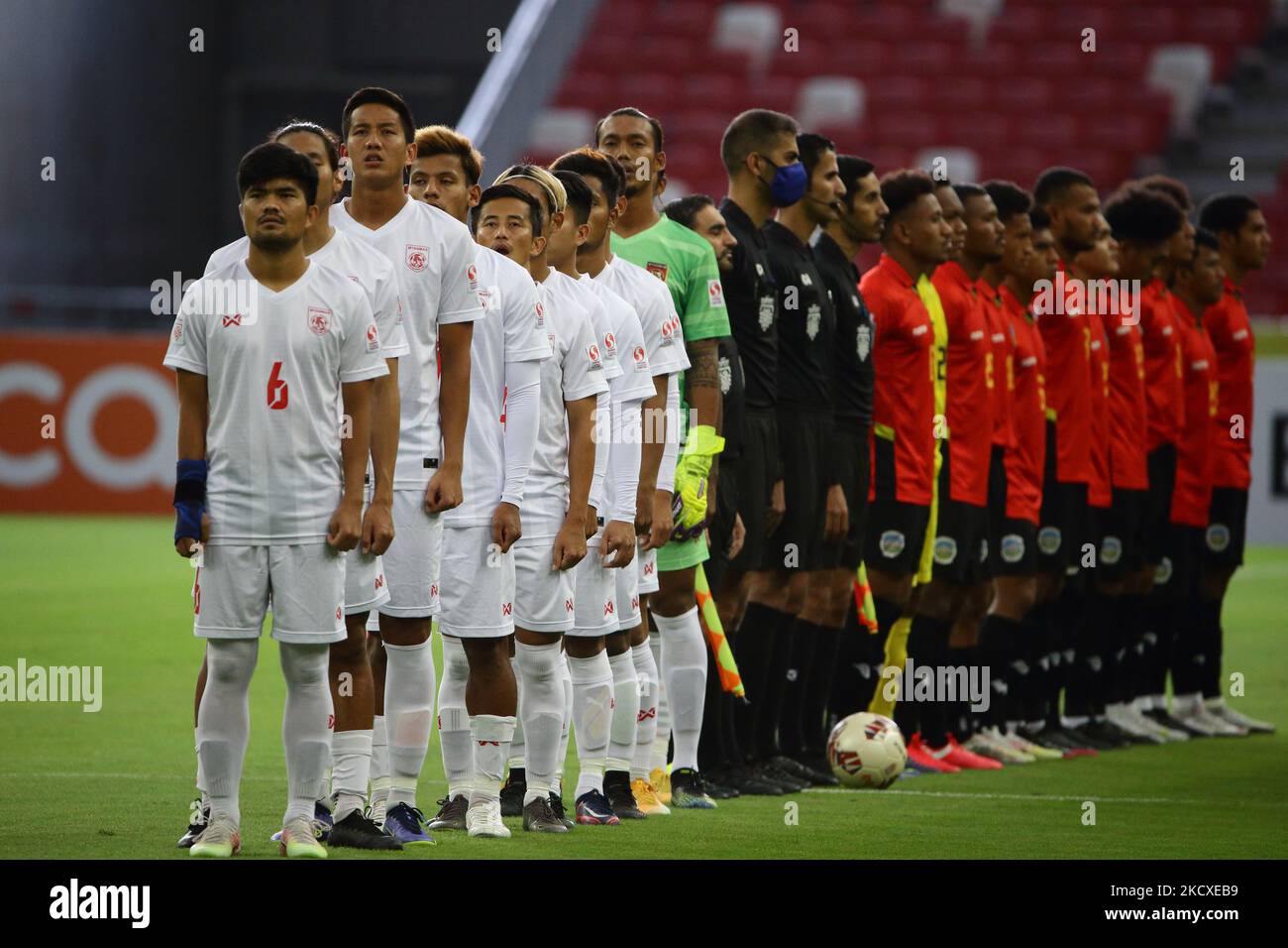 Myanmars players (L) sing the national anthem during the AFF Suzuki Cup ...