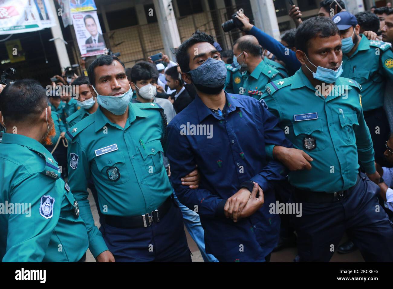 Police escort a convicted student in a court after a verdict over Buet ...