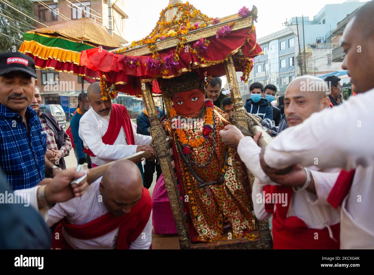 Nepalese Priests carry the idol of Rato Machindranath on a chariot ...