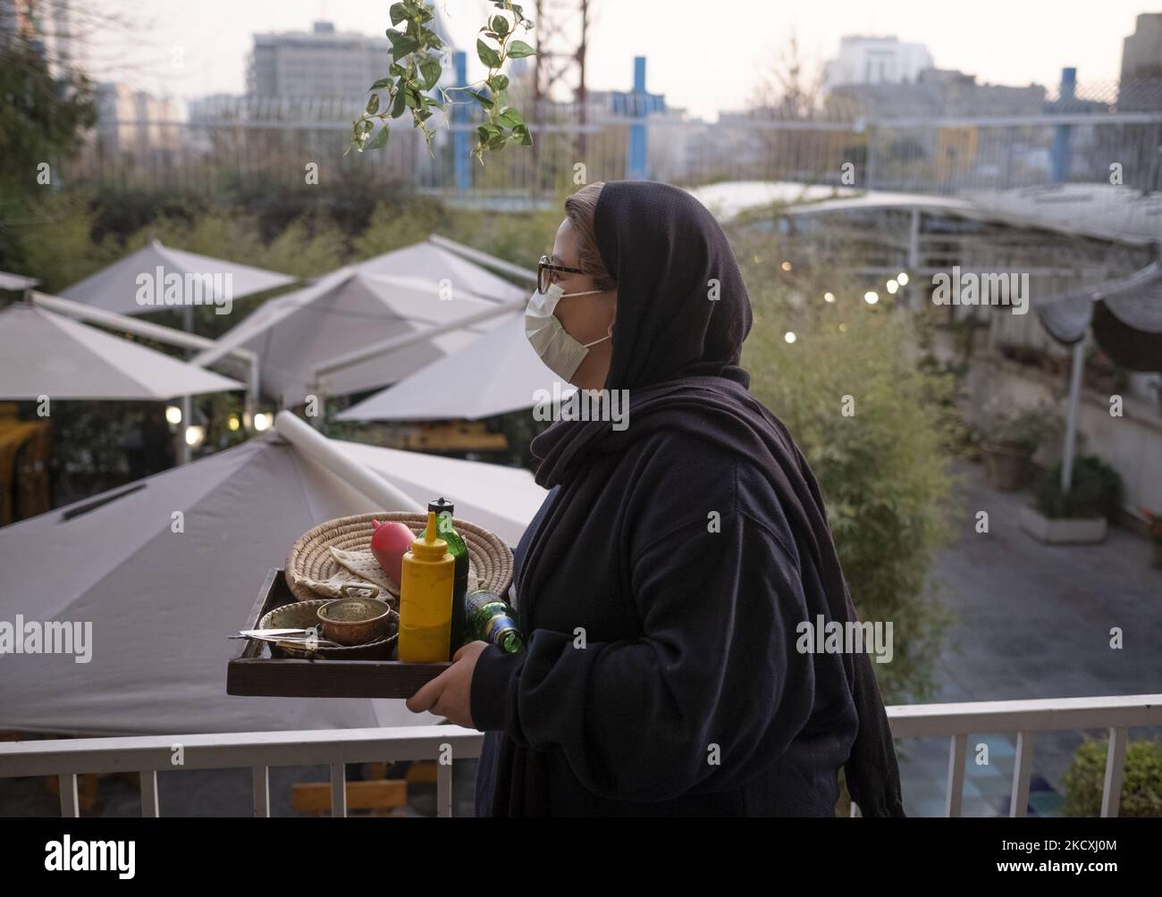 An Iranian cafe-woman works in a cafe in downtown Tehran on December 9 ...