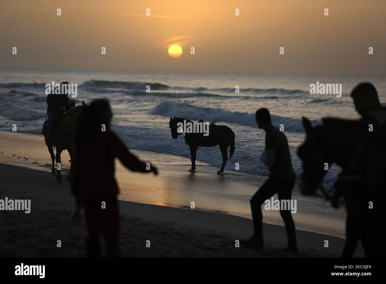 Palestinians enjoy during the sunset on the beach, in Gaza City, Dec ...