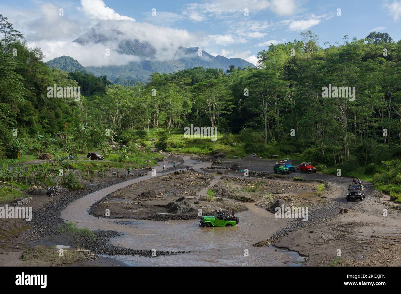 Tourists ride off-road car at Kali Kuning river in the slope of Merapi ...