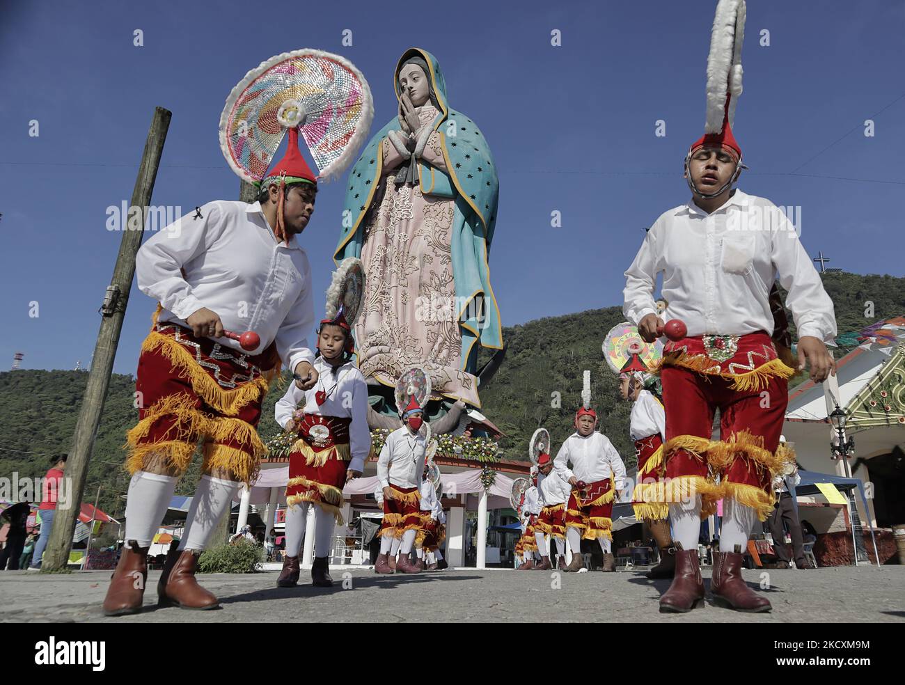 Dancers and pilgrims perform the Dance of the Quetzals in the square of ...