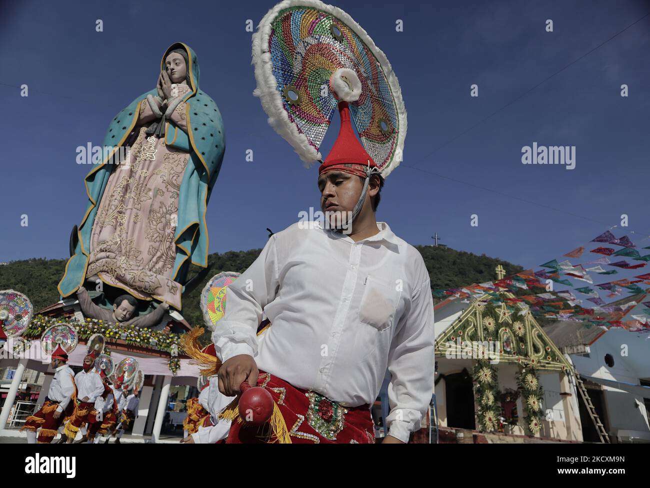 Dancers and pilgrims perform the Dance of the Quetzals in the square of ...
