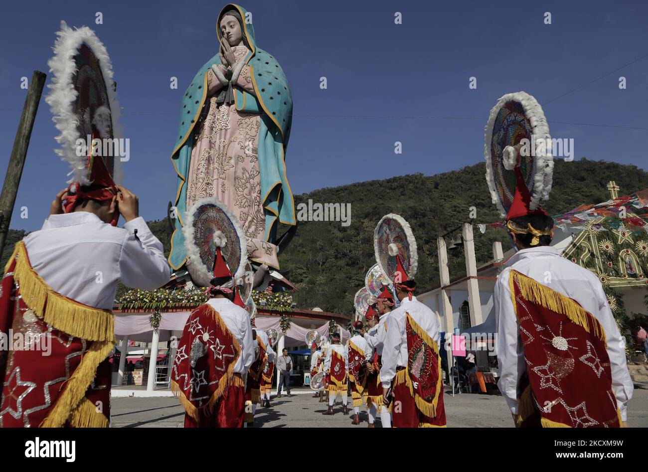 Dancers and pilgrims perform the Dance of the Quetzals in the square of ...