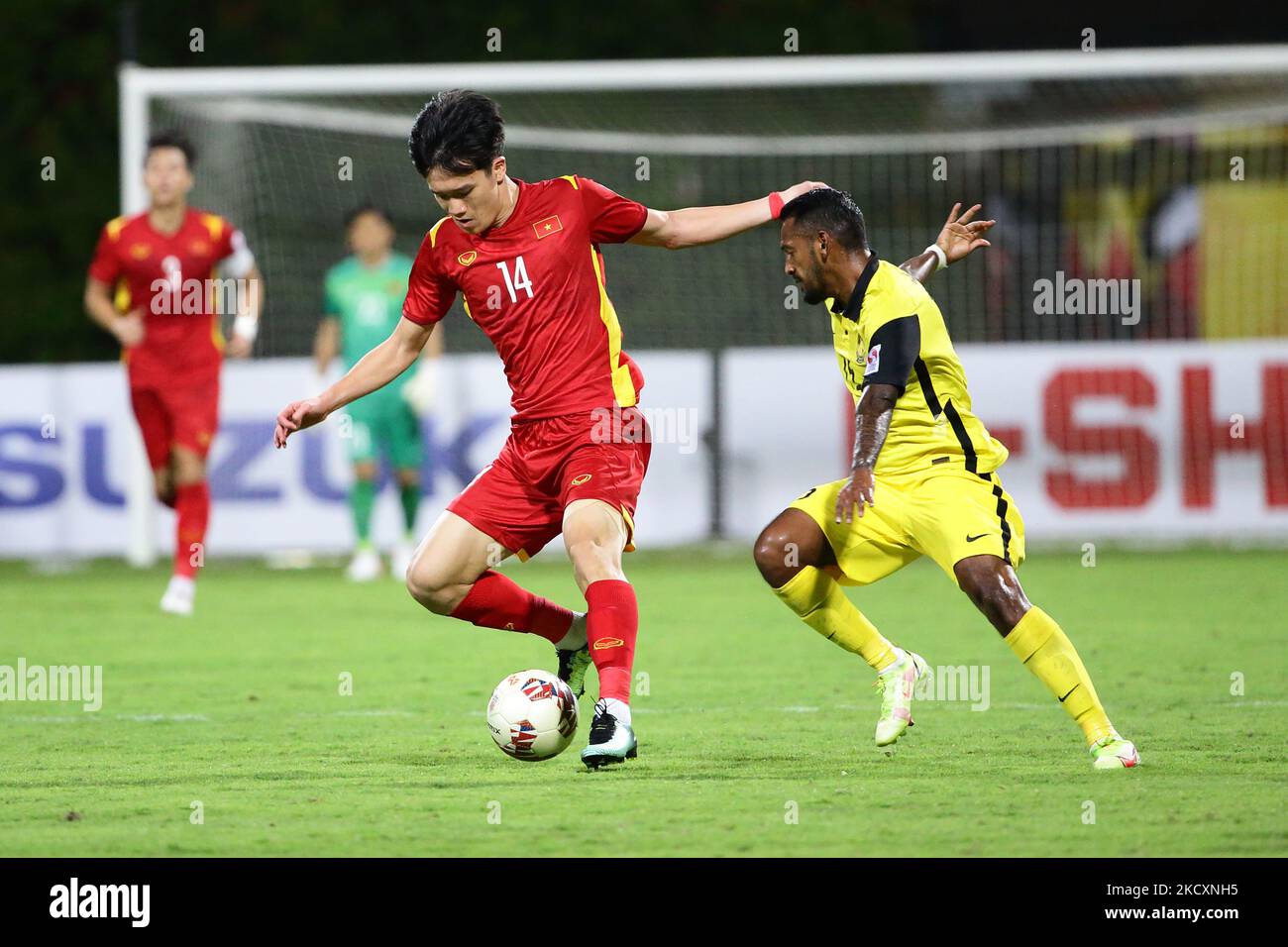 Nguyen Hoang Duc of Vietnam (L) dribbles Kogileswaran Raj Mohana Raj of Malaysia during the AFF ...