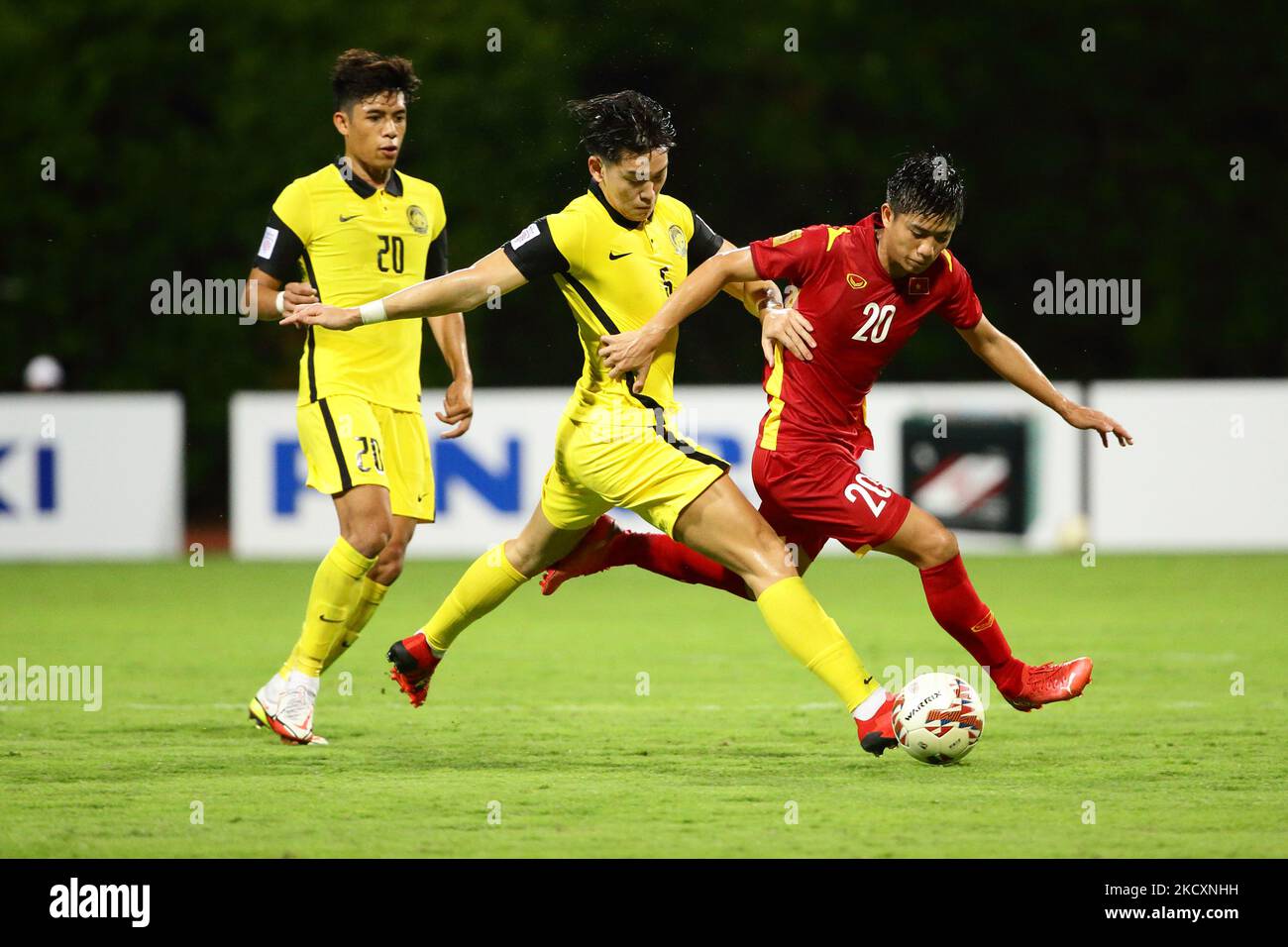 Dominic Tan Jun Jin of Malaysia (L) challenges Phan Van Duc of Vietnam for the ball during the ...
