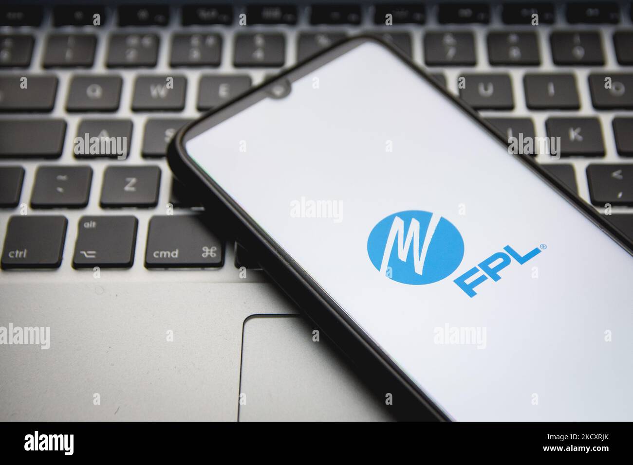 In this photo illustration a Florida Power and Light logo seen displayed on a smartphone screen ...