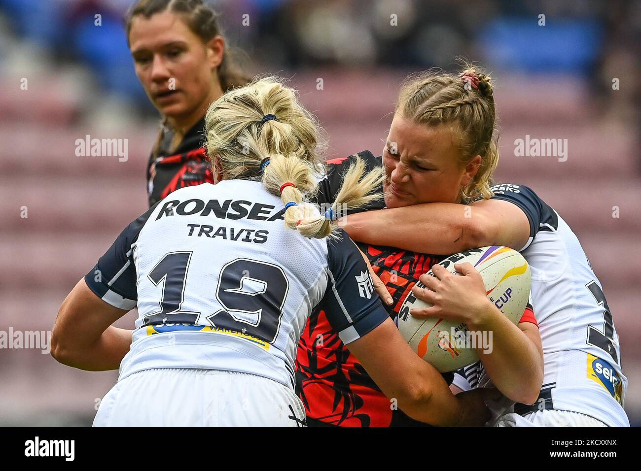 Rachel Chaboter of Canada is tackled by Vicky Molyneux and Paige Travis ...
