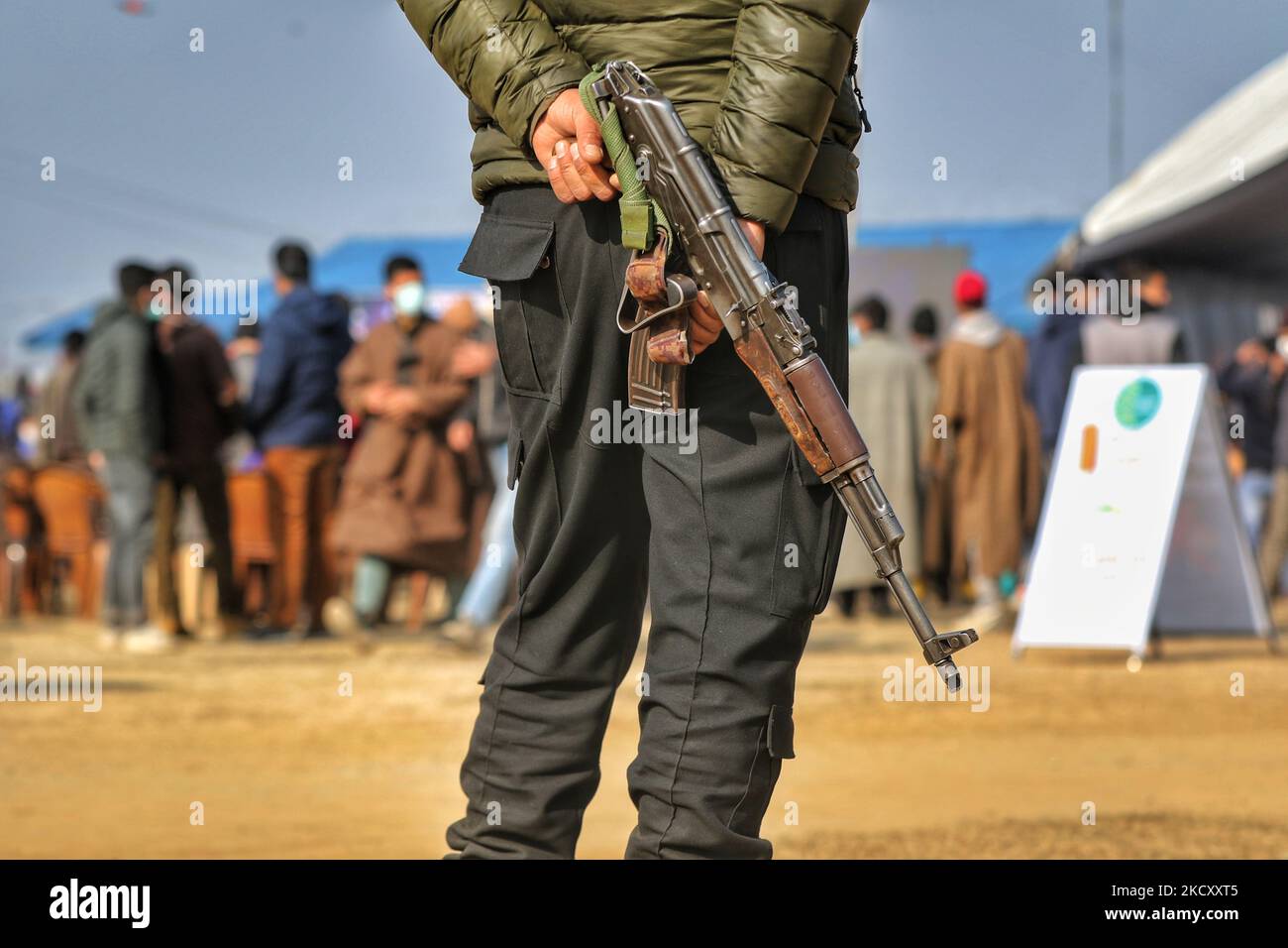 A police Cop holds an AK-47 (Avtomat Kalashnikova) assault rifle as he ...