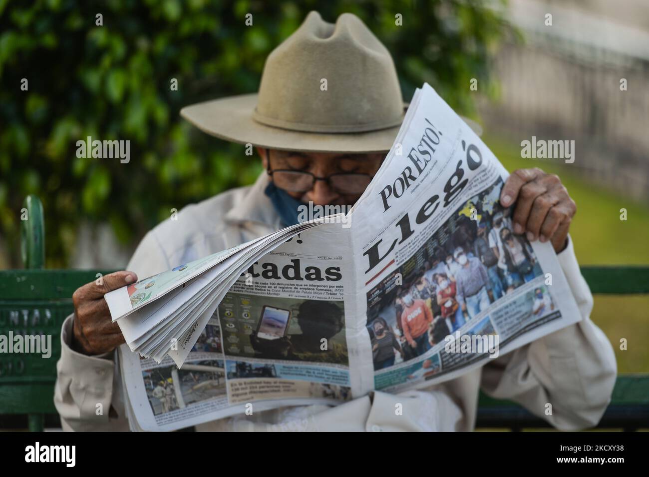 A local man reads 'Por Esto!' (English: 'That's Why!'), a daily Mexican ...