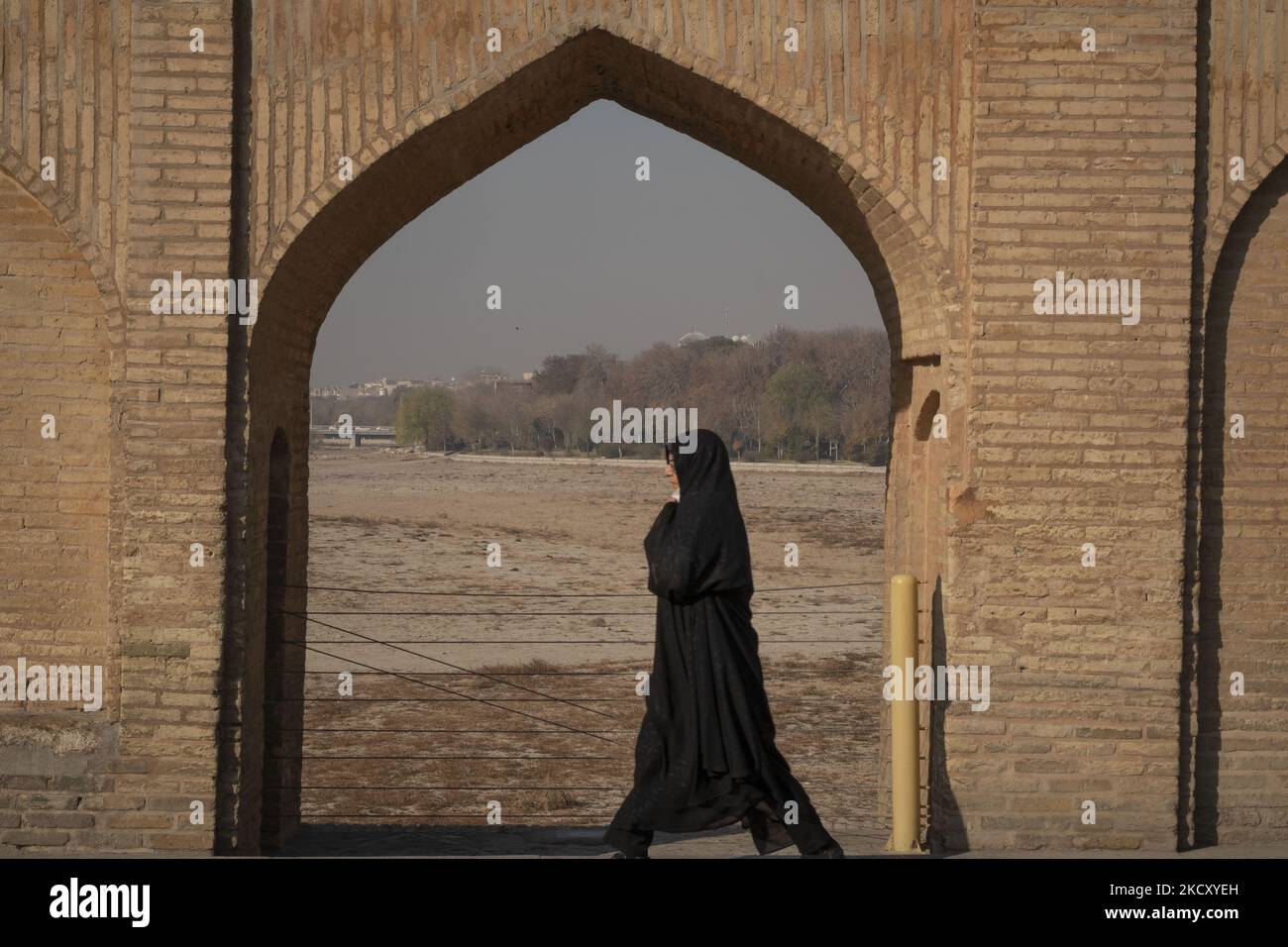 An Iranian woman walks along the Si-o-se-pol (33-Bridge) historical ...