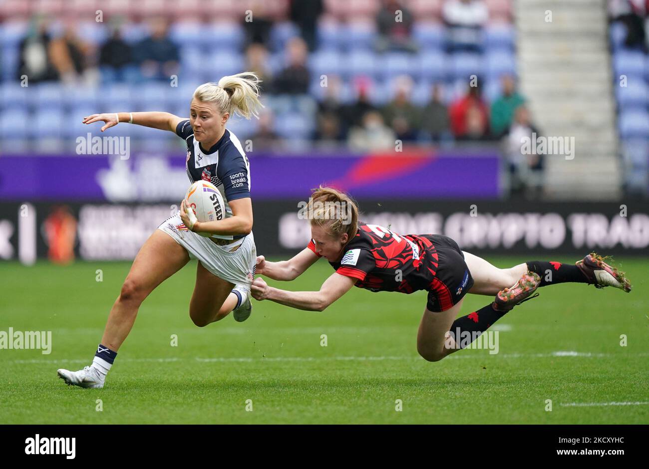 England's Tara-Jane Stanley (left) is tackled by Canada's Petra Woods ...