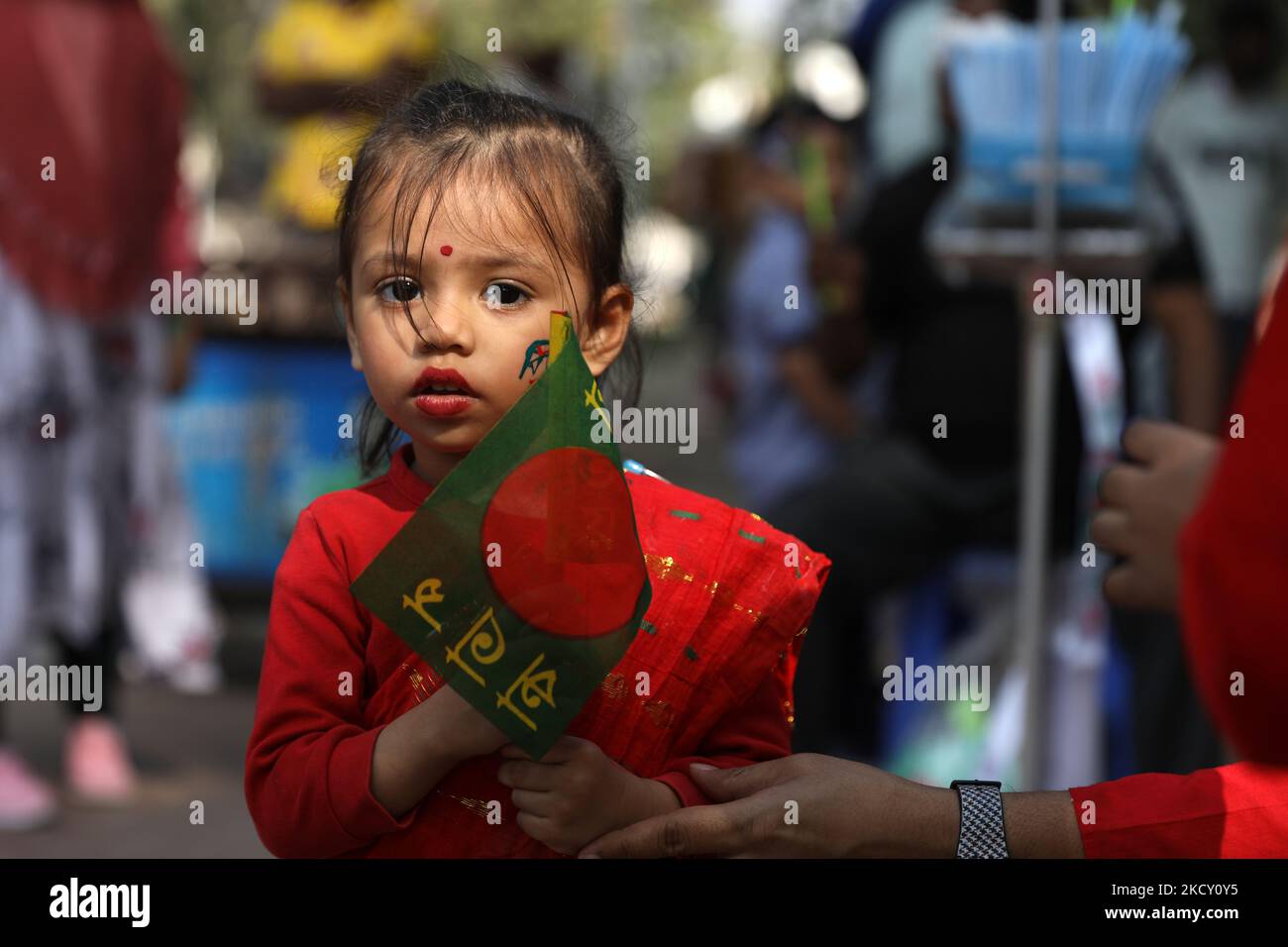A Bangladeshi child holds a national flag during the celebrations of ...
