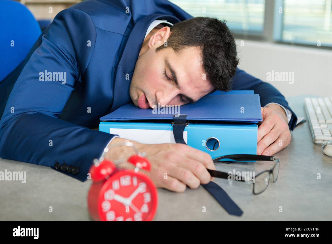 a businessman sleeping on desk Stock Photo - Alamy