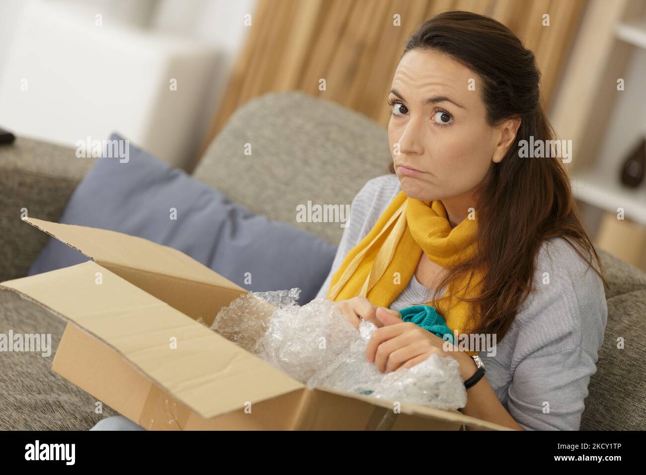 disappointed woman opening box Stock Photo - Alamy