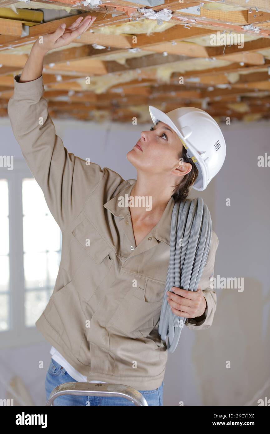 female electrician holding replacement wiring Stock Photo - Alamy