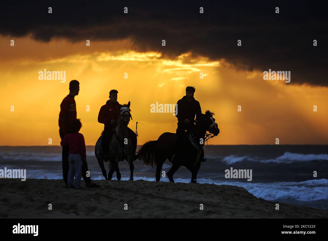 Palestinians ride their horses in front of Gaza Beach during sunset ...