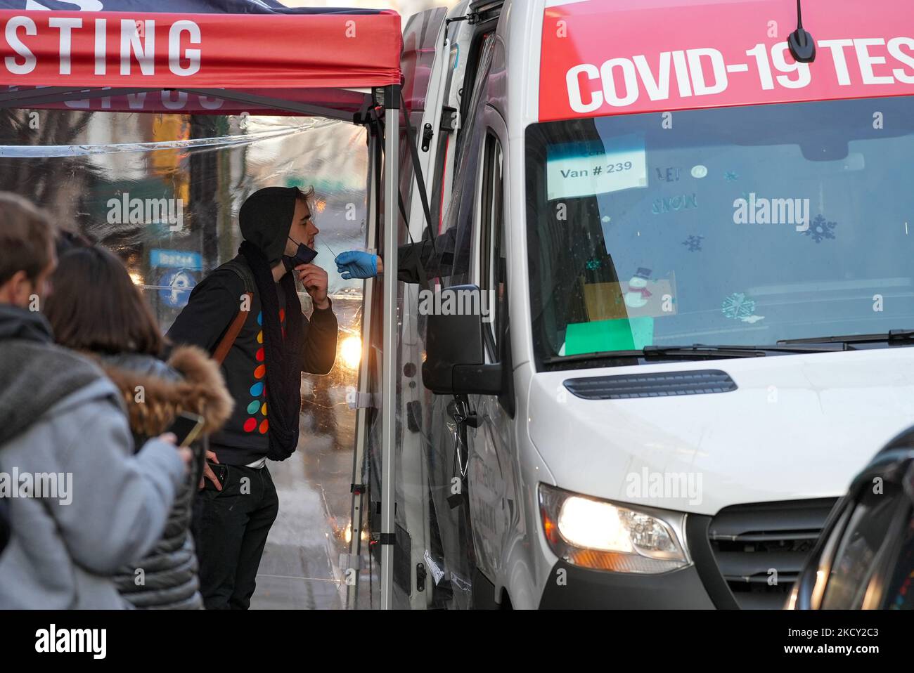 Groups of people line-up to get tested for Covid-19 on December 17 ...