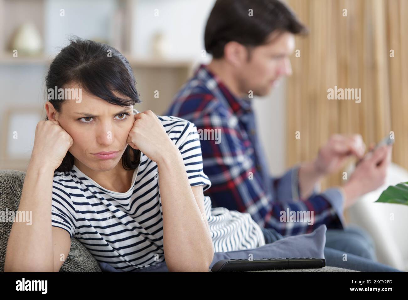 bored young girl sitting on sofa Stock Photo - Alamy