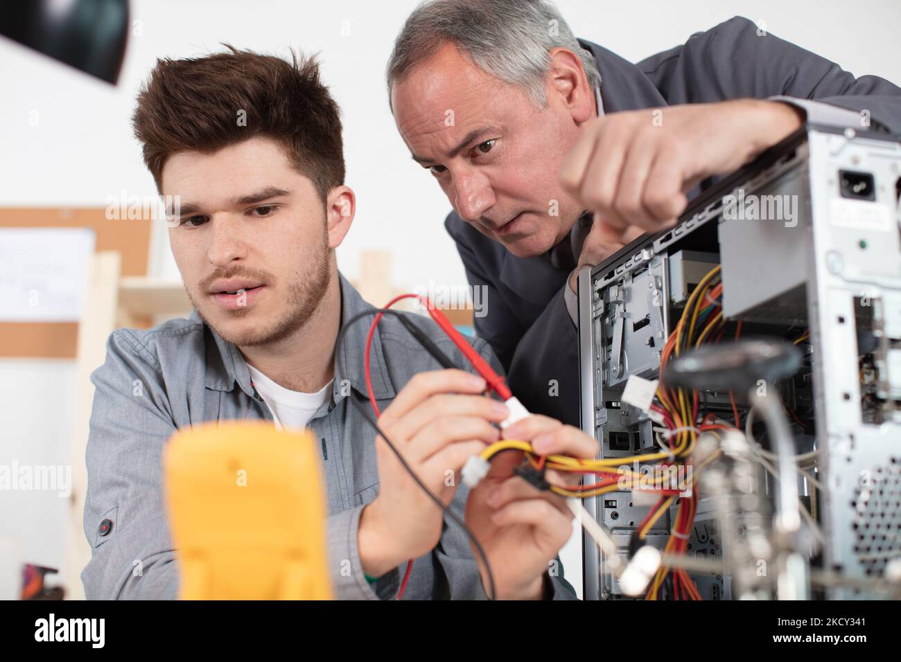 Repairman testing computer multimeter hi-res stock photography and ...