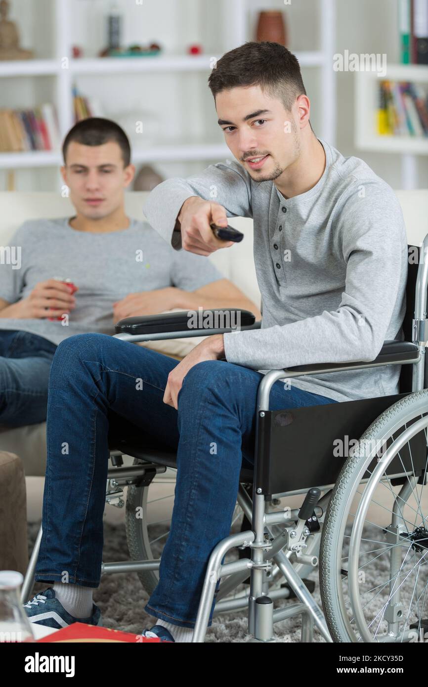 handicap man and friends watching television Stock Photo - Alamy