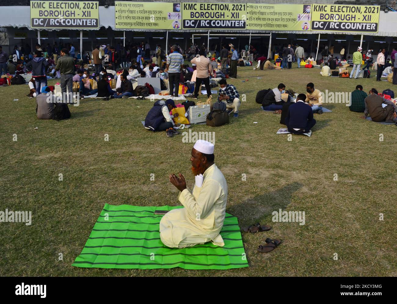 A man prays on a field of Electronic Voting Machine (EVM) distribution ...