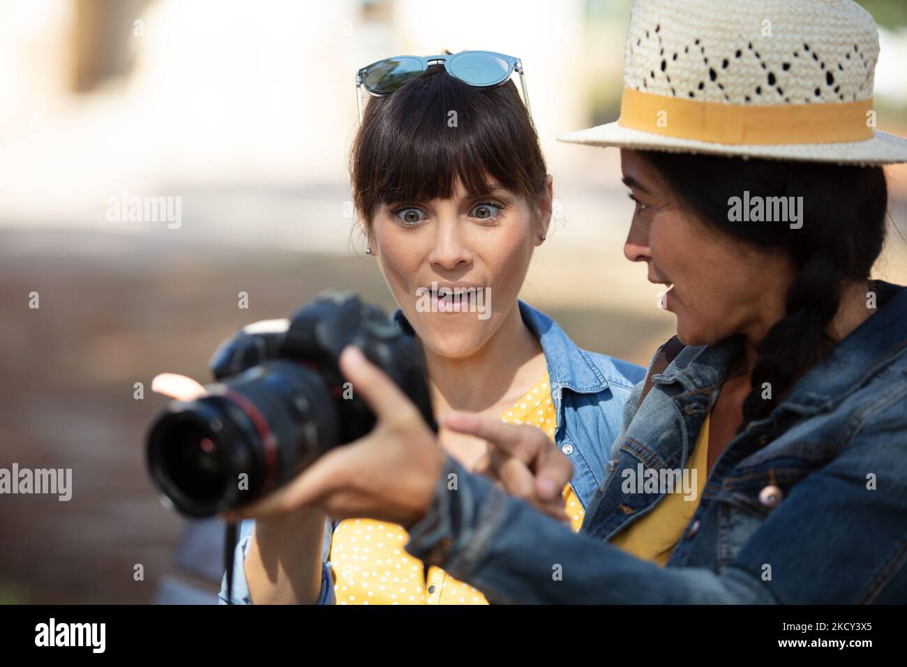 women are looking at funny picture Stock Photo - Alamy
