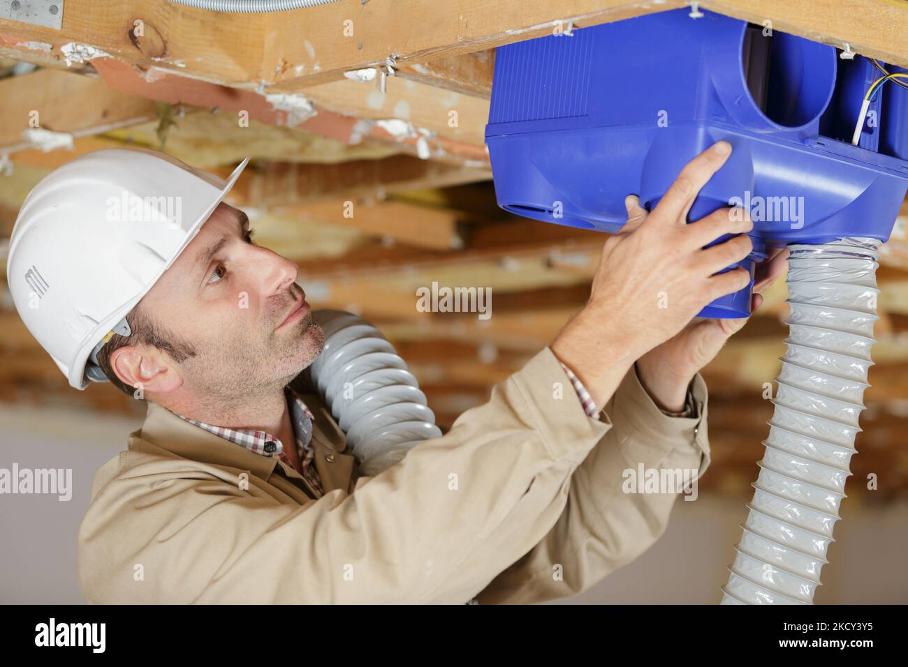 man installing an air conditioning unit Stock Photo - Alamy