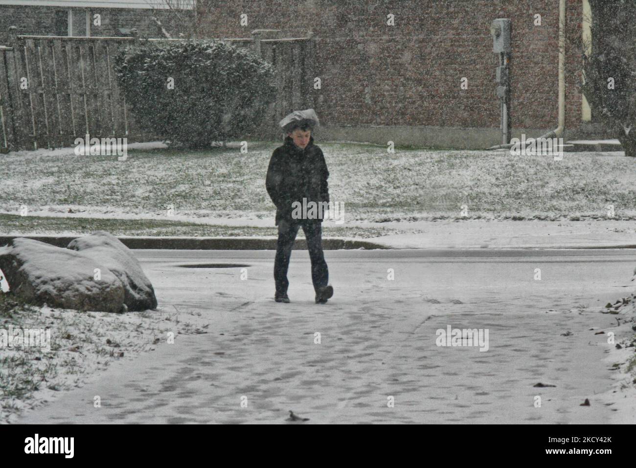 Boy walking in the snow during a snowfall that left around 5 ...