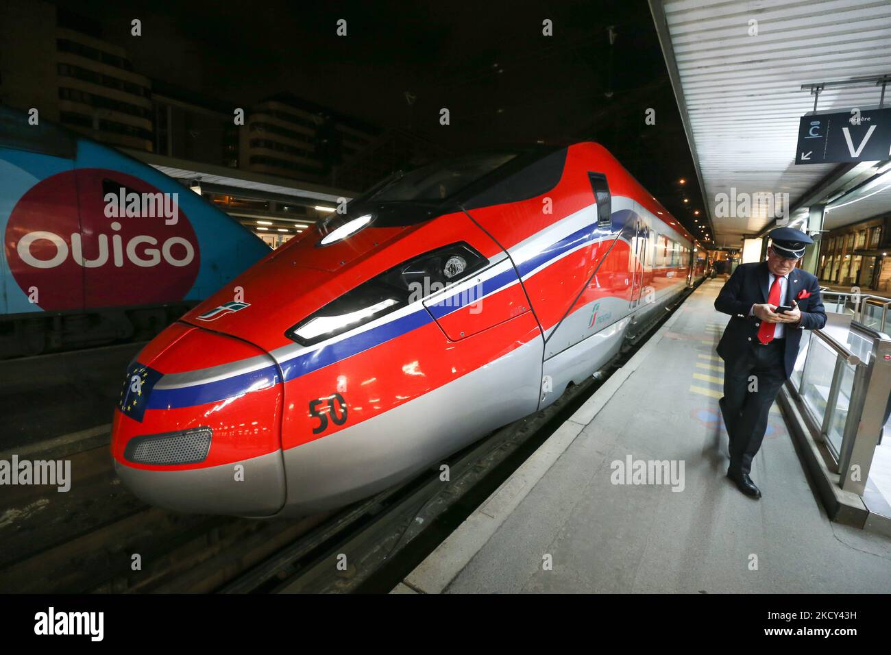 A photograph taken on December 18, 2021 shows a OUIGO train (back) past ...