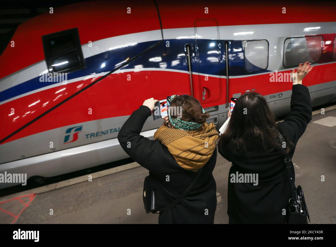 People salute the departure of the first Frecciarossa, a high-speed train of the Italian ...