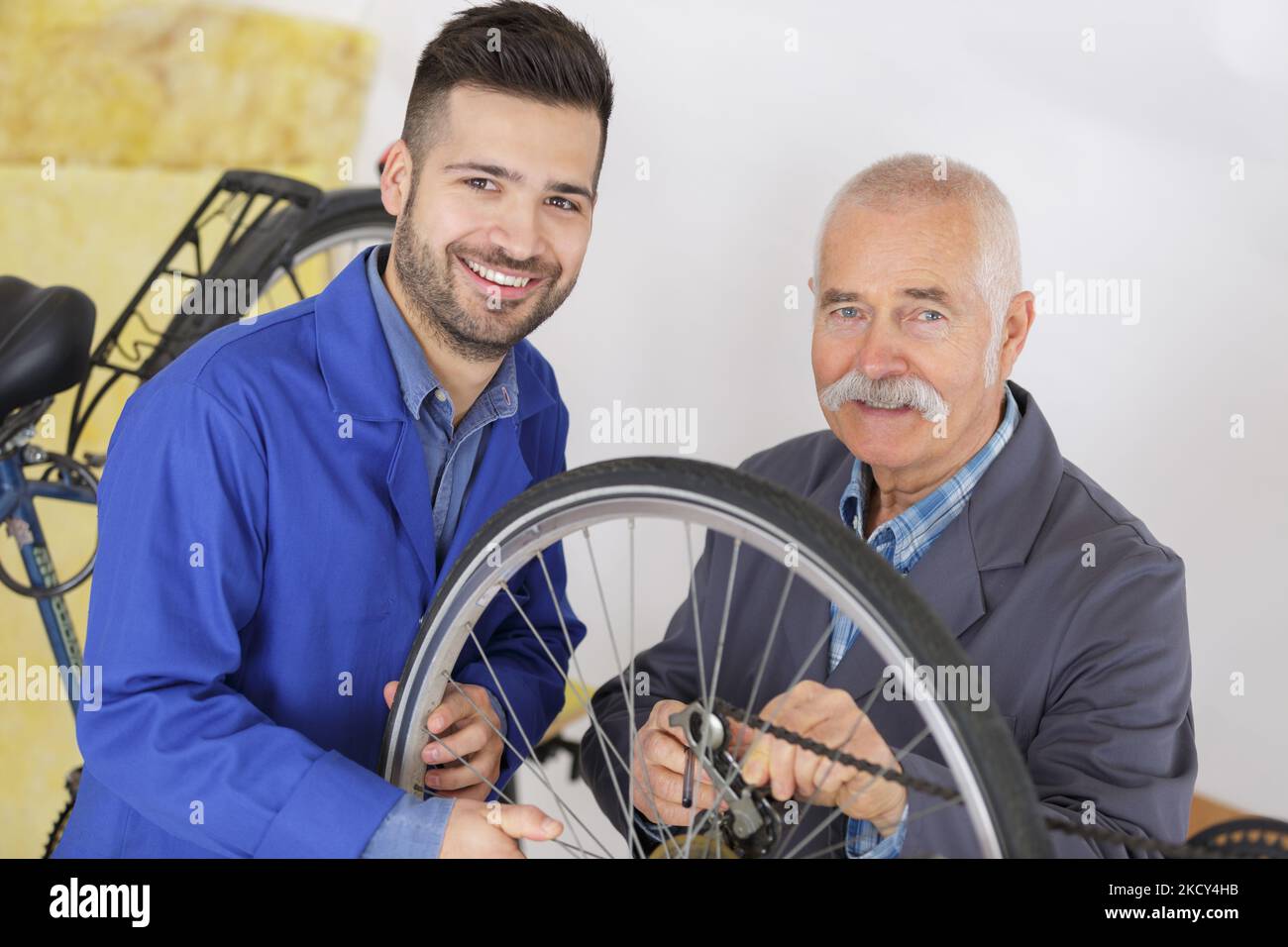 bicycle trainee mechanic and master working on mountain bike Stock ...