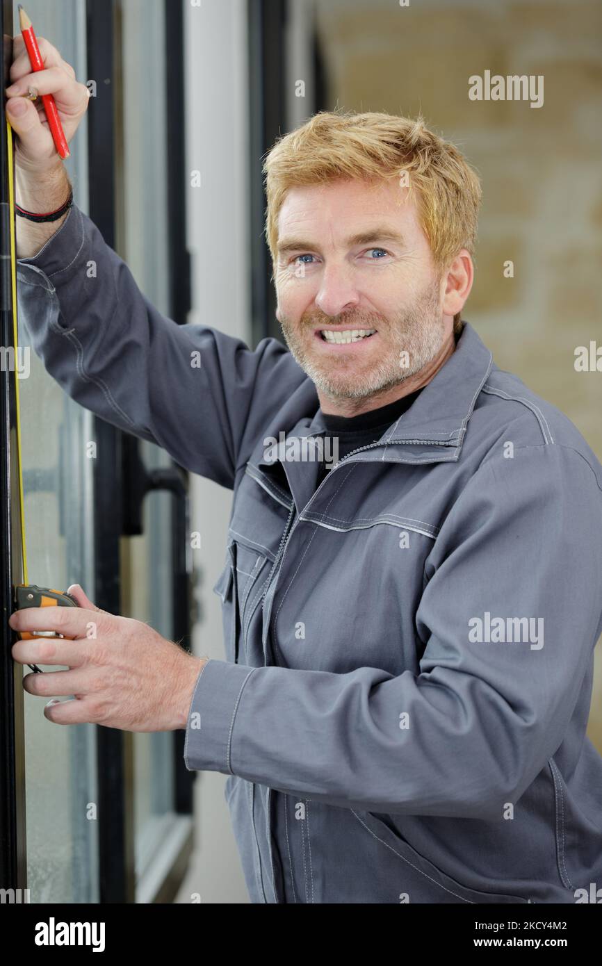 happy man measuring a window Stock Photo - Alamy