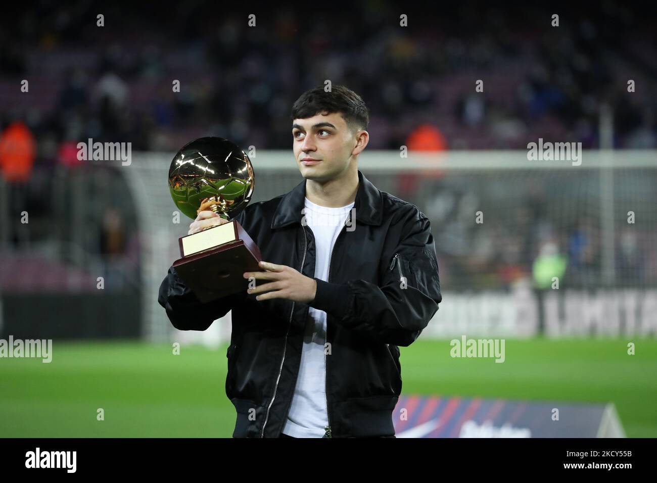 Pedri offering the Golden Boy trophy to the supporters during the match ...