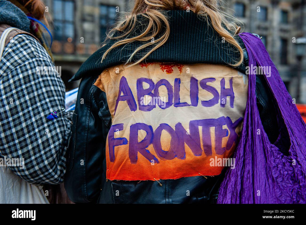 A woman is wearing a patch on her back against Frontex, during the demonstration in support of ...