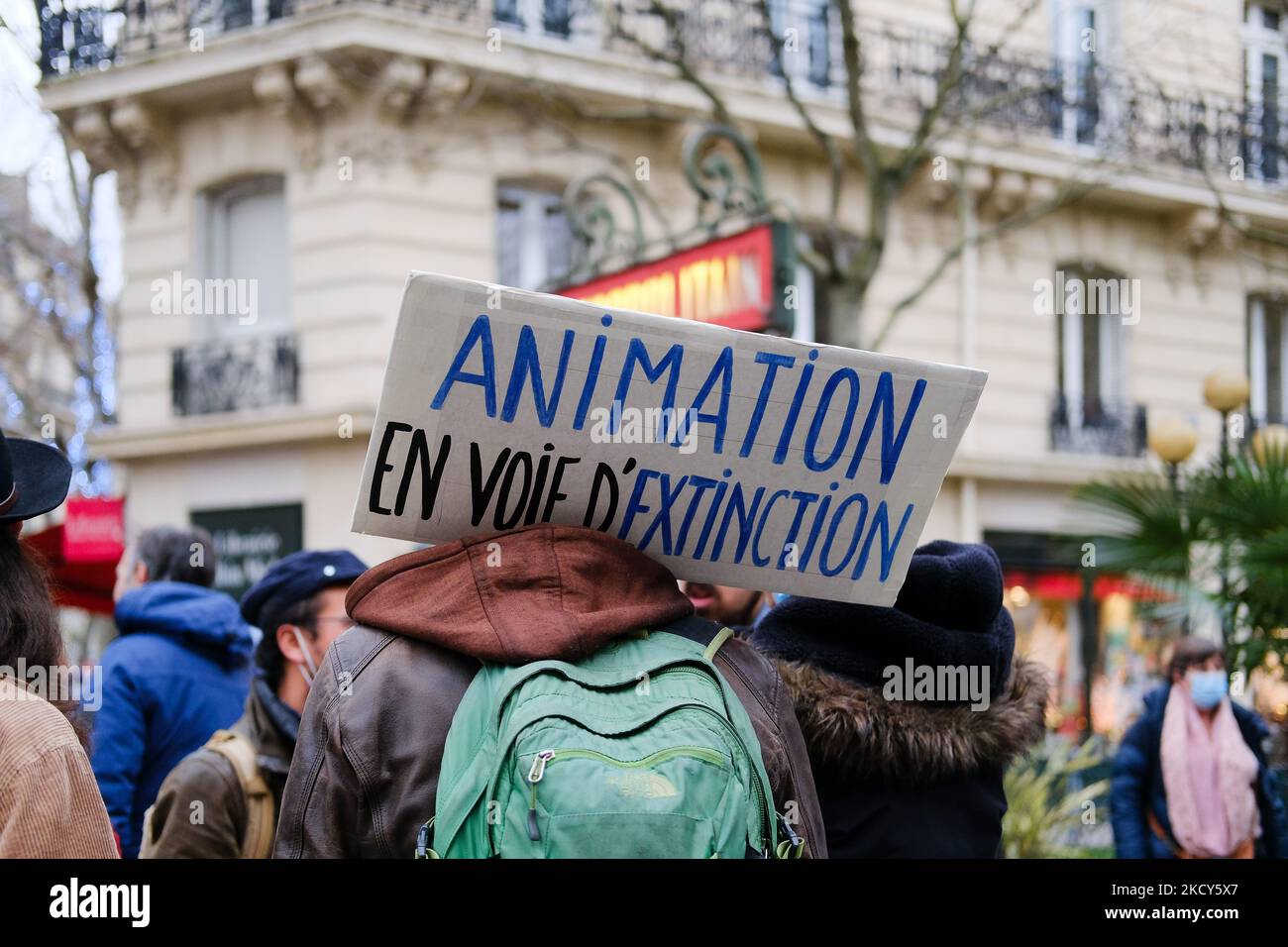 A protester carries an "endangered animation" sign, in Paris, France ...