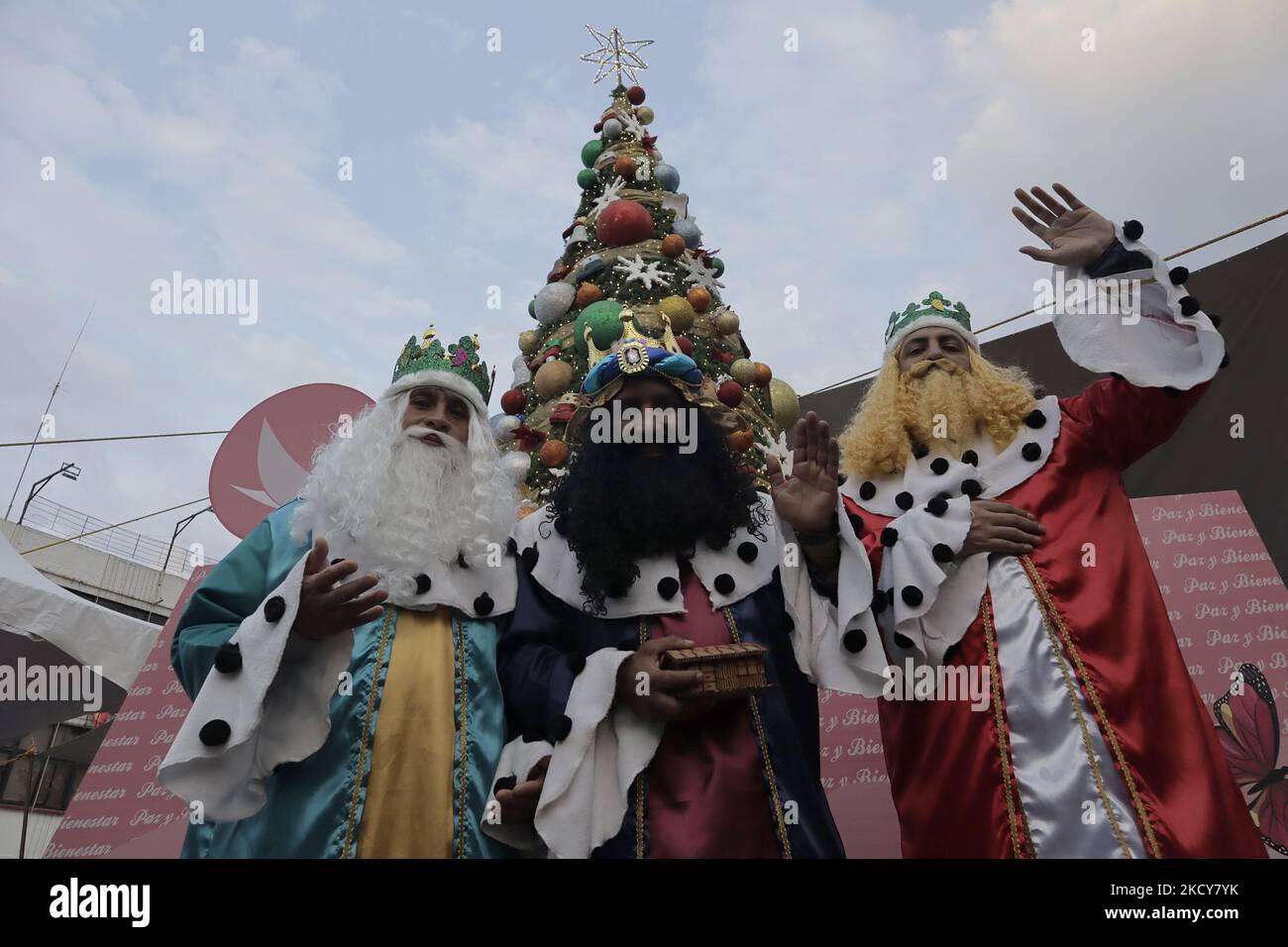 People dressed as the Three Wise Men pose in a Christmas village ...