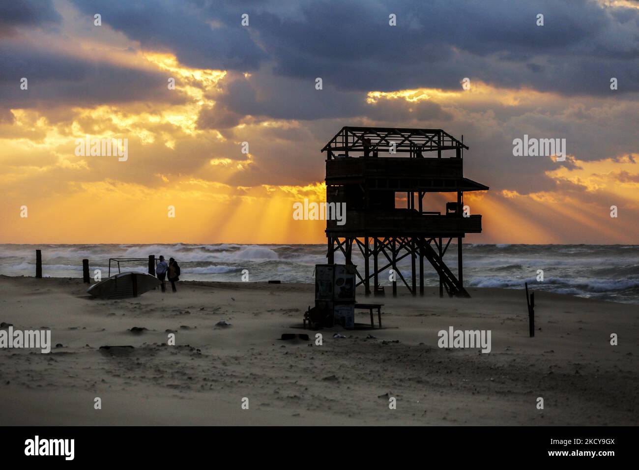 Palestinians walk in front of Gaza Beach during stormy weather, on ...