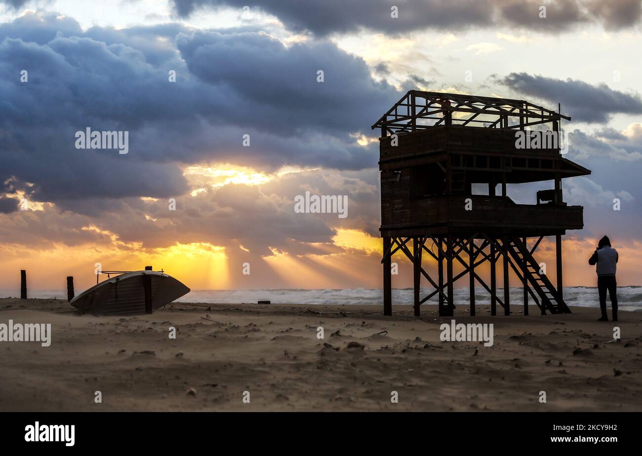 A Palestinian man walk in front of Gaza Beach during stormy weather, on ...