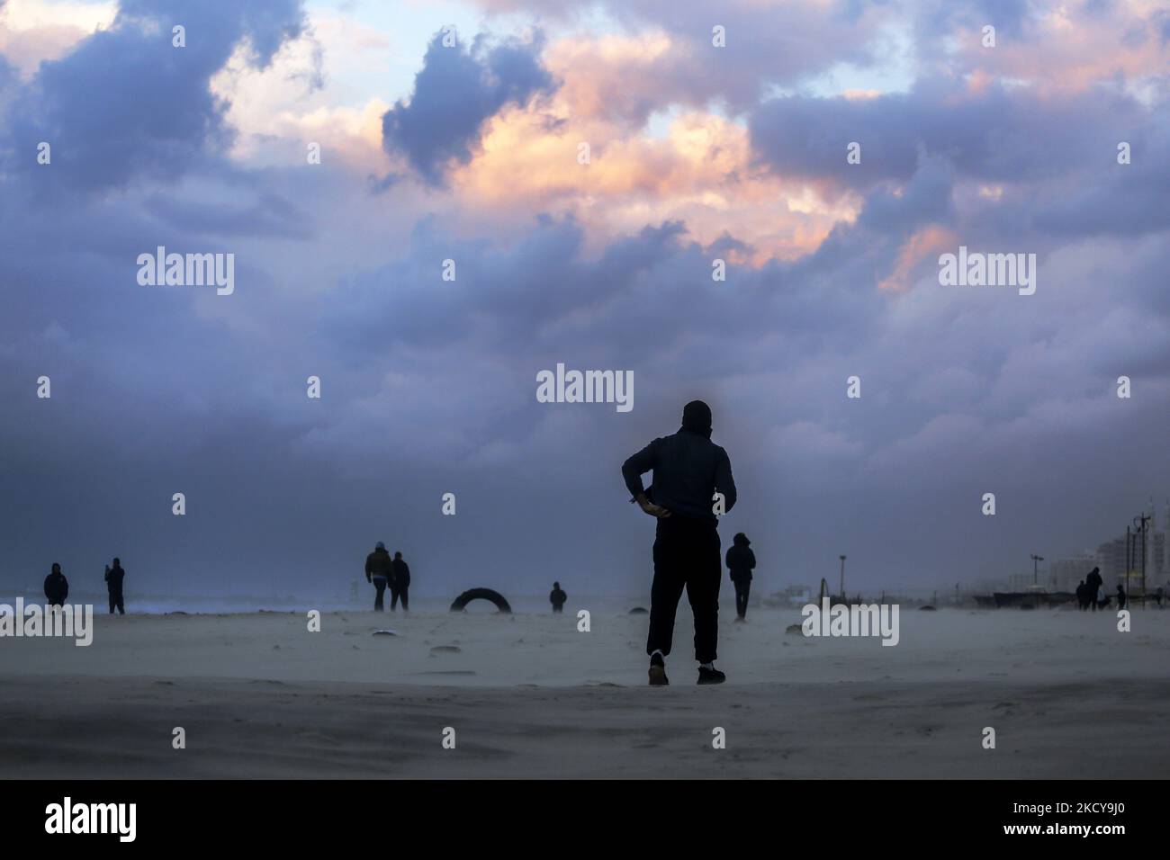 Palestinians walk in front of Gaza Beach during stormy weather, on ...