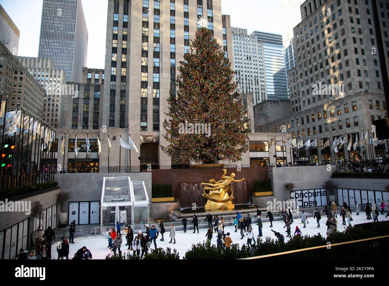 Holiday revelers take photographs with the Rockefeller Center Christmas ...