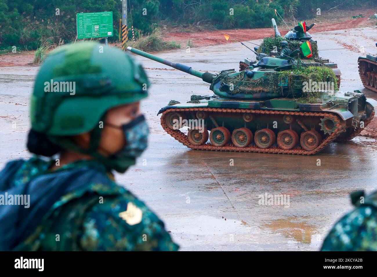 Taiwanese Soldiers stand guard as CM-11 tanks are deployed to a live ...