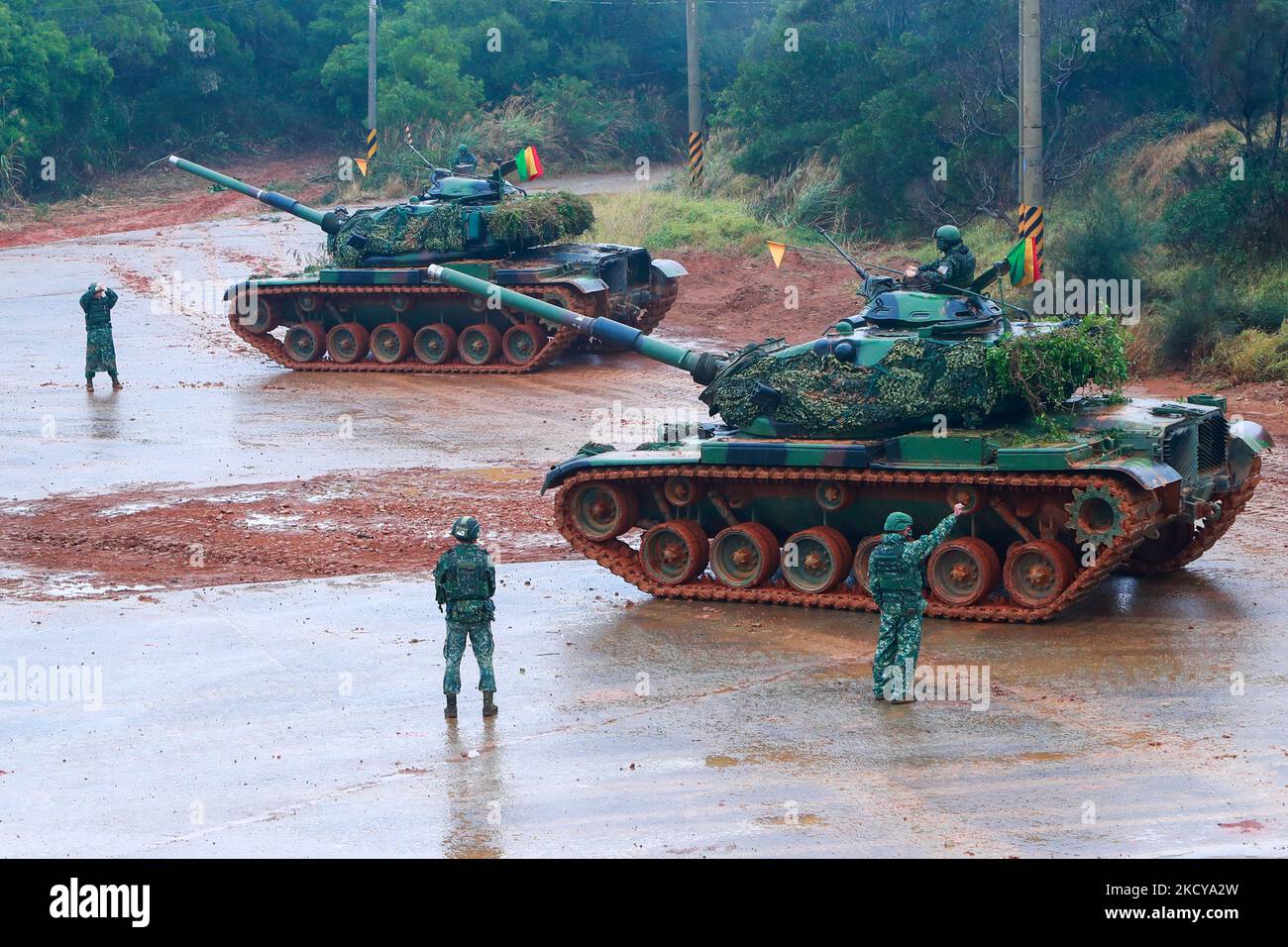 Taiwanese Soldiers stand guard as CM-11 tanks are deployed to a live ...