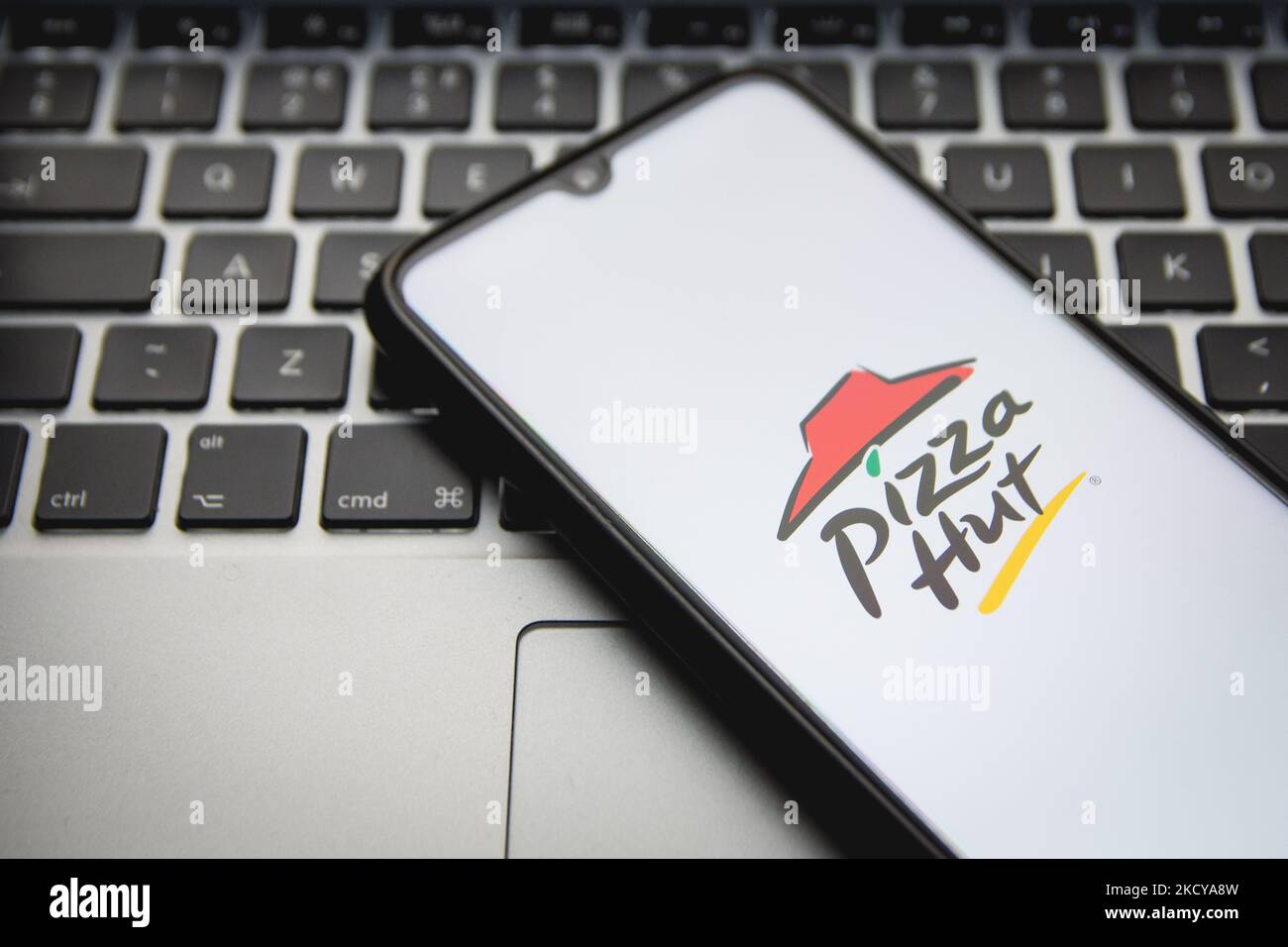 In this photo illustration a Pizza Hut logo seen displayed on a ...