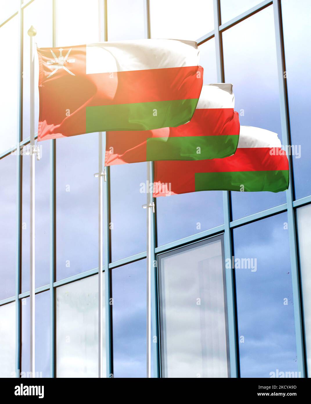 Flagpoles with the flag of Oman in front of the business center Stock ...