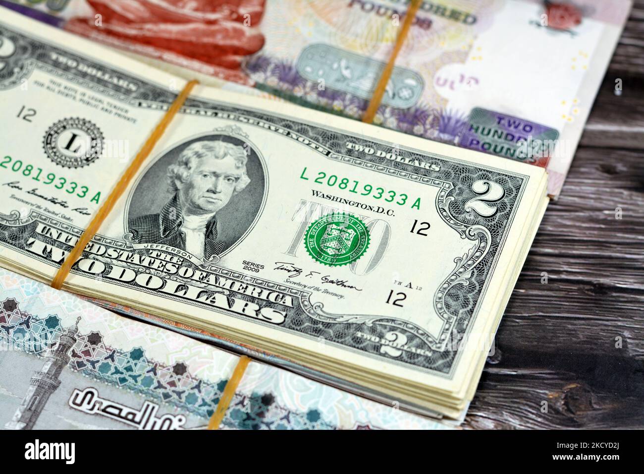 Stacks of Egyptian and American currency cash money banknotes with ...