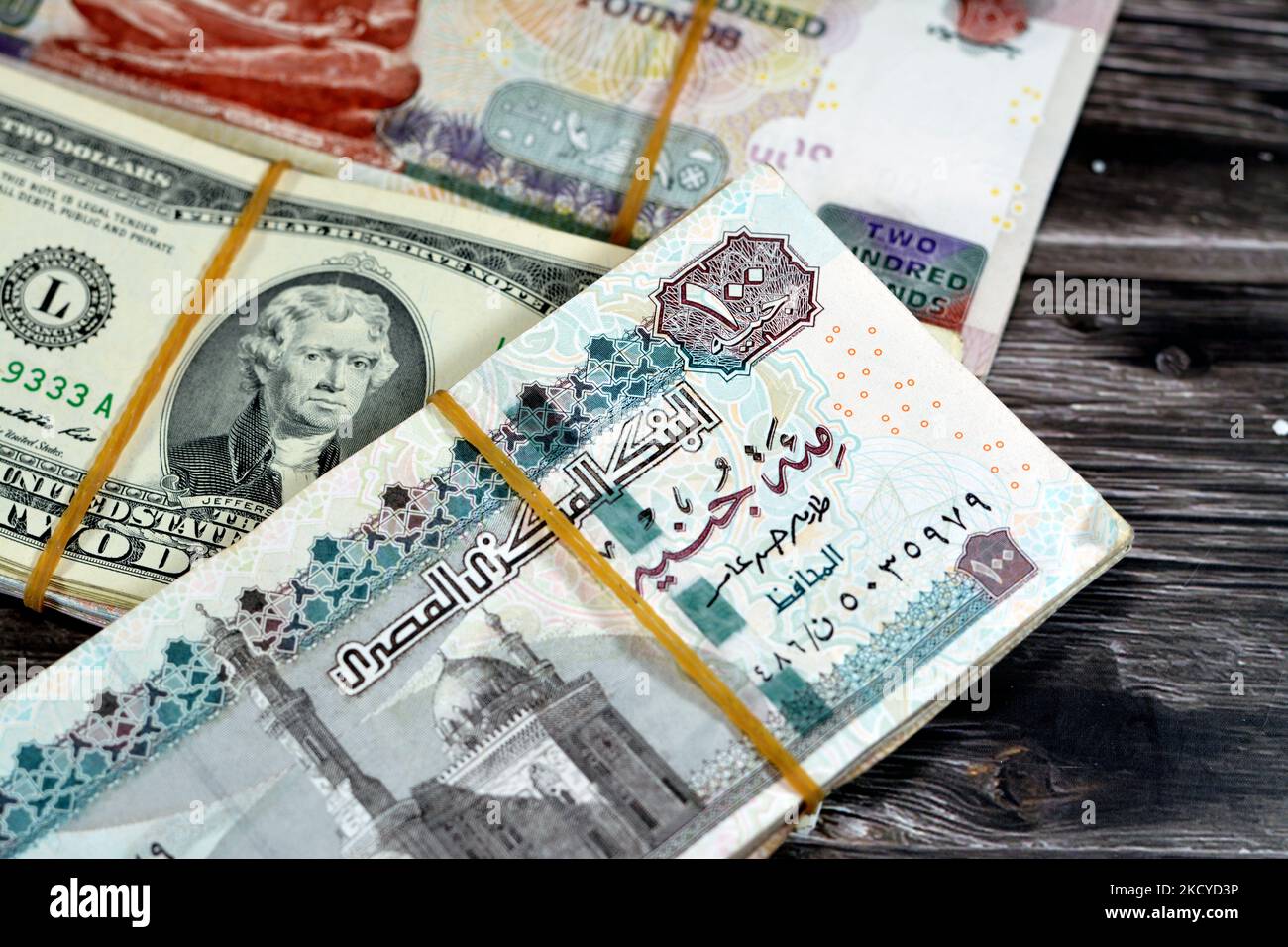 Stacks of Egyptian and American currency cash money banknotes with ...