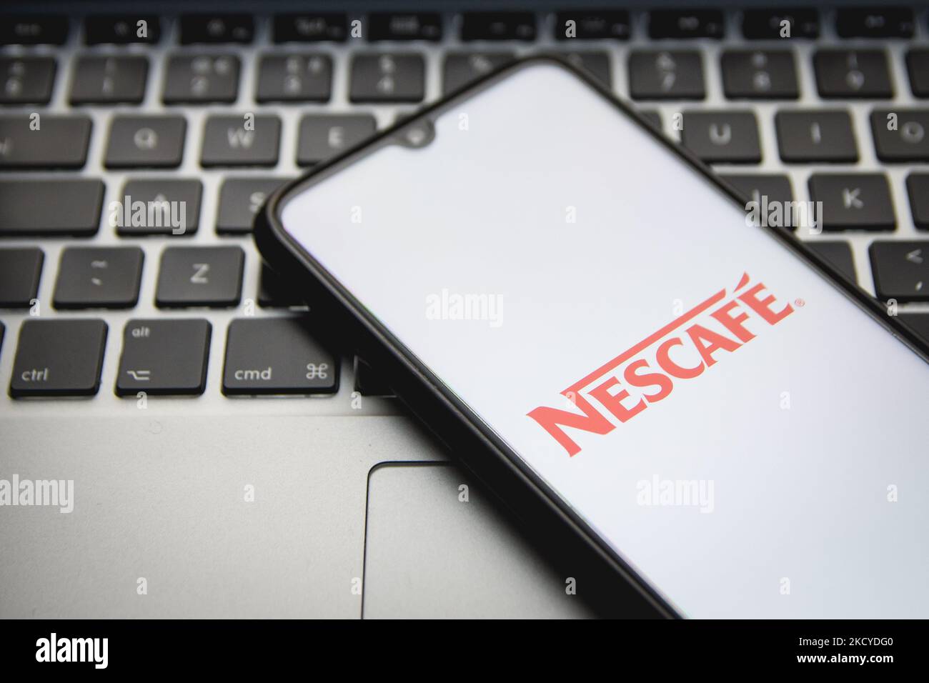 In this photo illustration a Nescafe logo seen displayed on a ...
